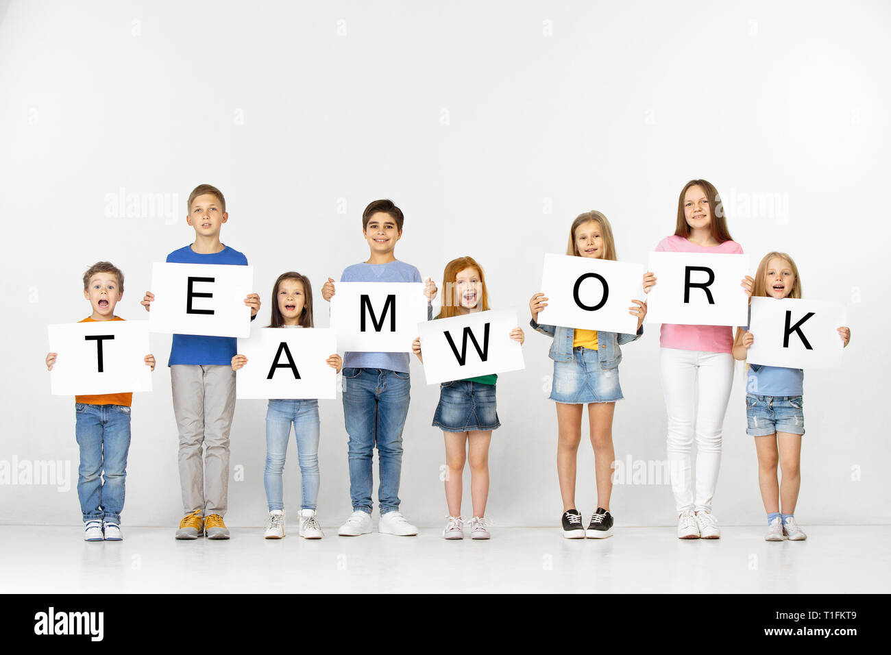 Teamwork is way to result. Group of happy smiling children and ...