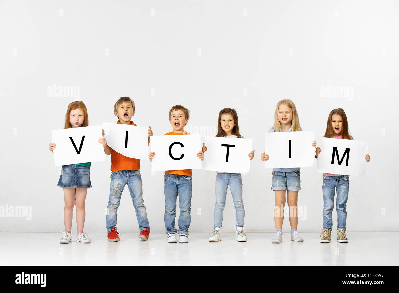 Victim of bad character. Group of angry screaming children with a white ...