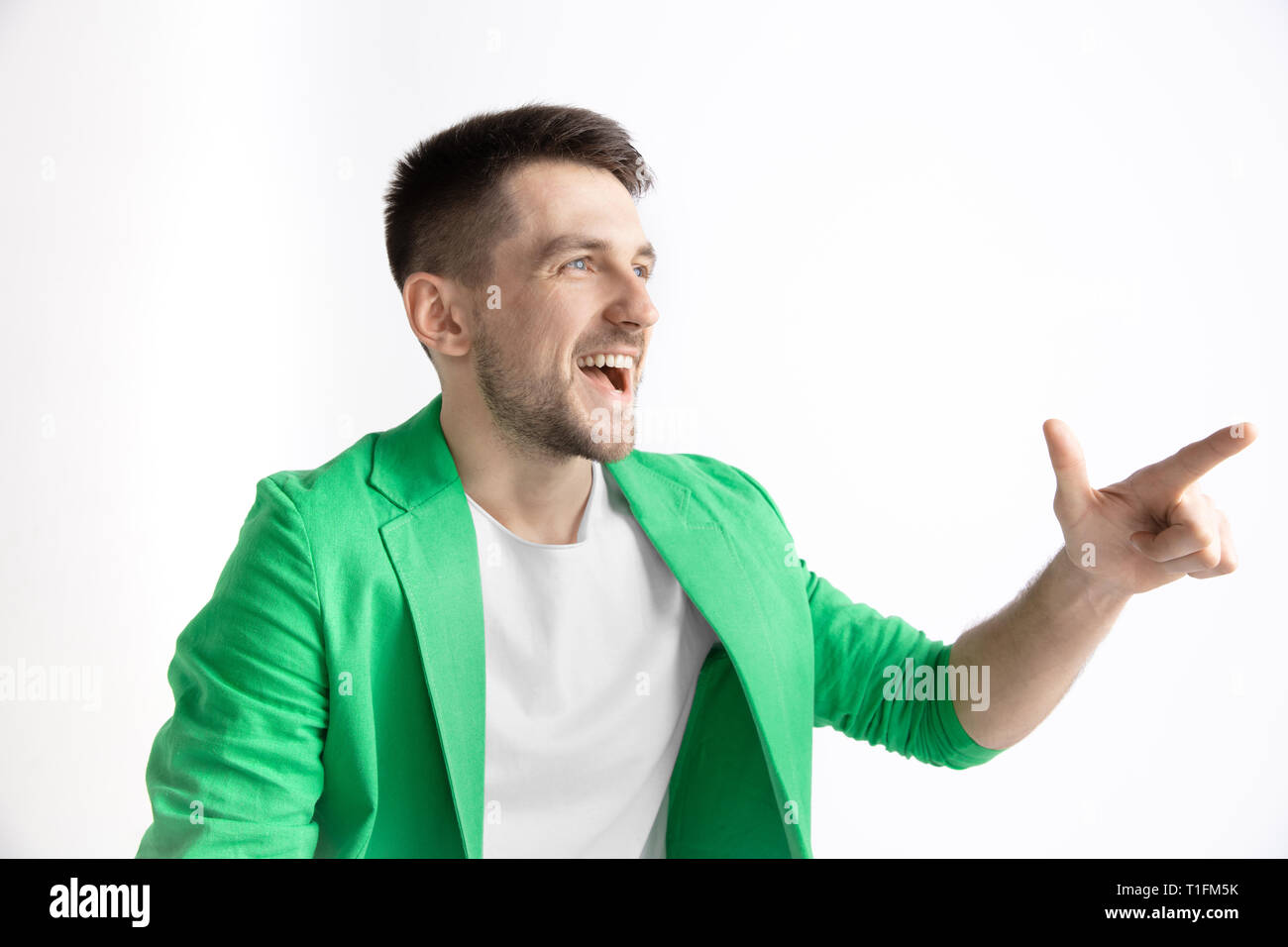 Happy business man standing, smiling and pointing to left isolated on ...