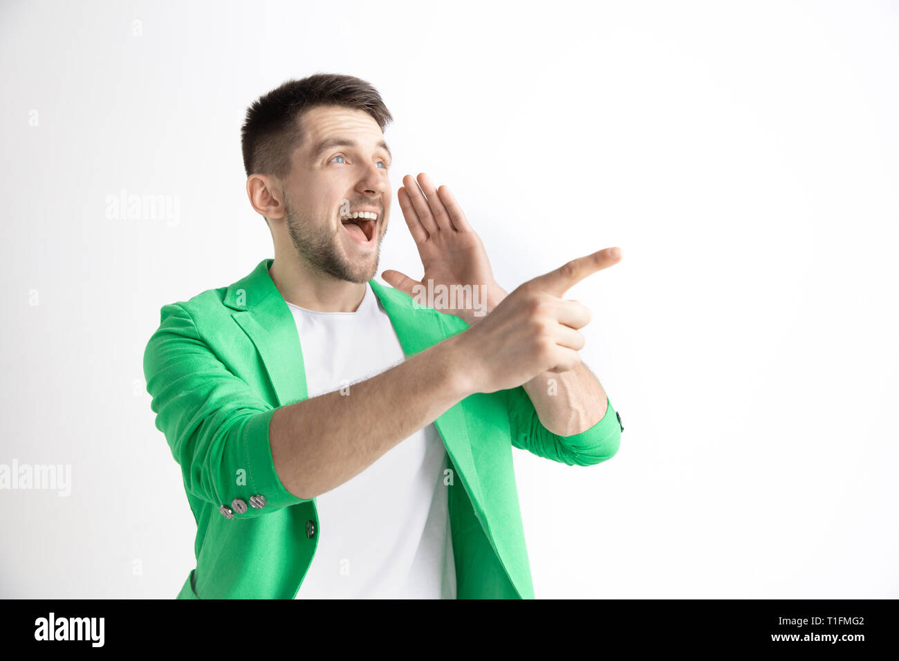 Happy business man standing, smiling and pointing to left isolated on ...