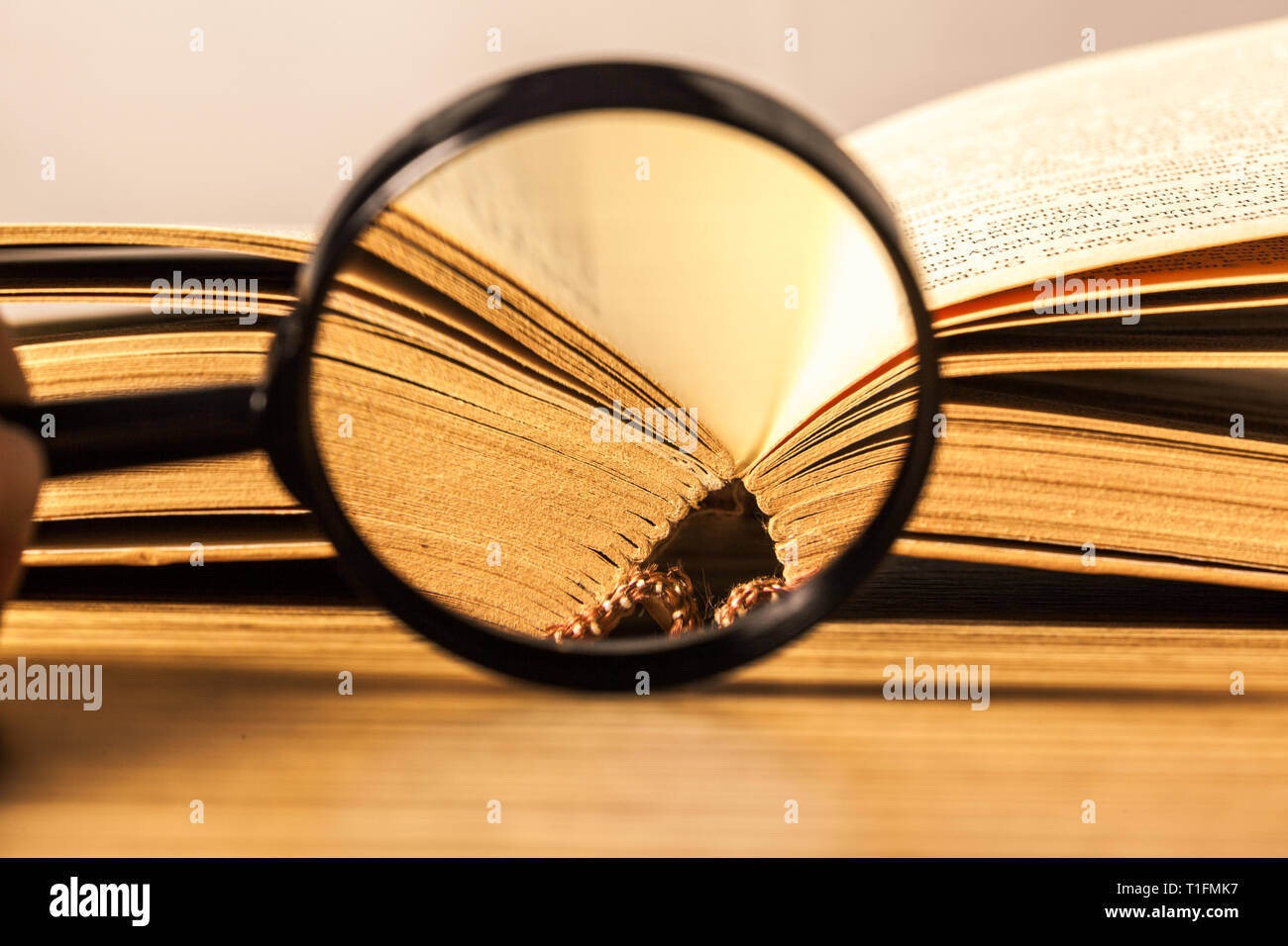 books and magnifying glass Stock Photo - Alamy
