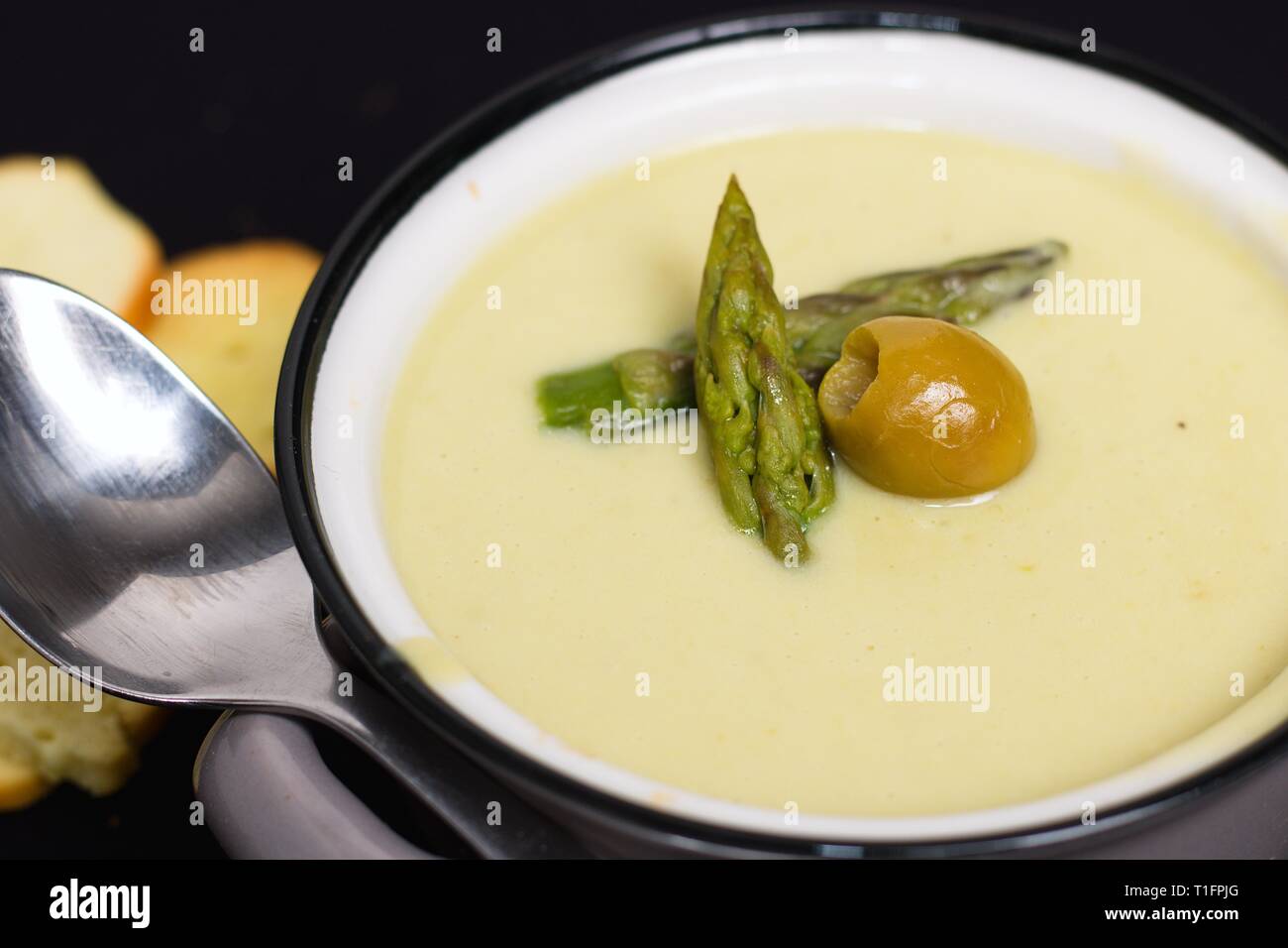 Vegetarian puree asparagus soup decorated by asparagus and olive Stock ...