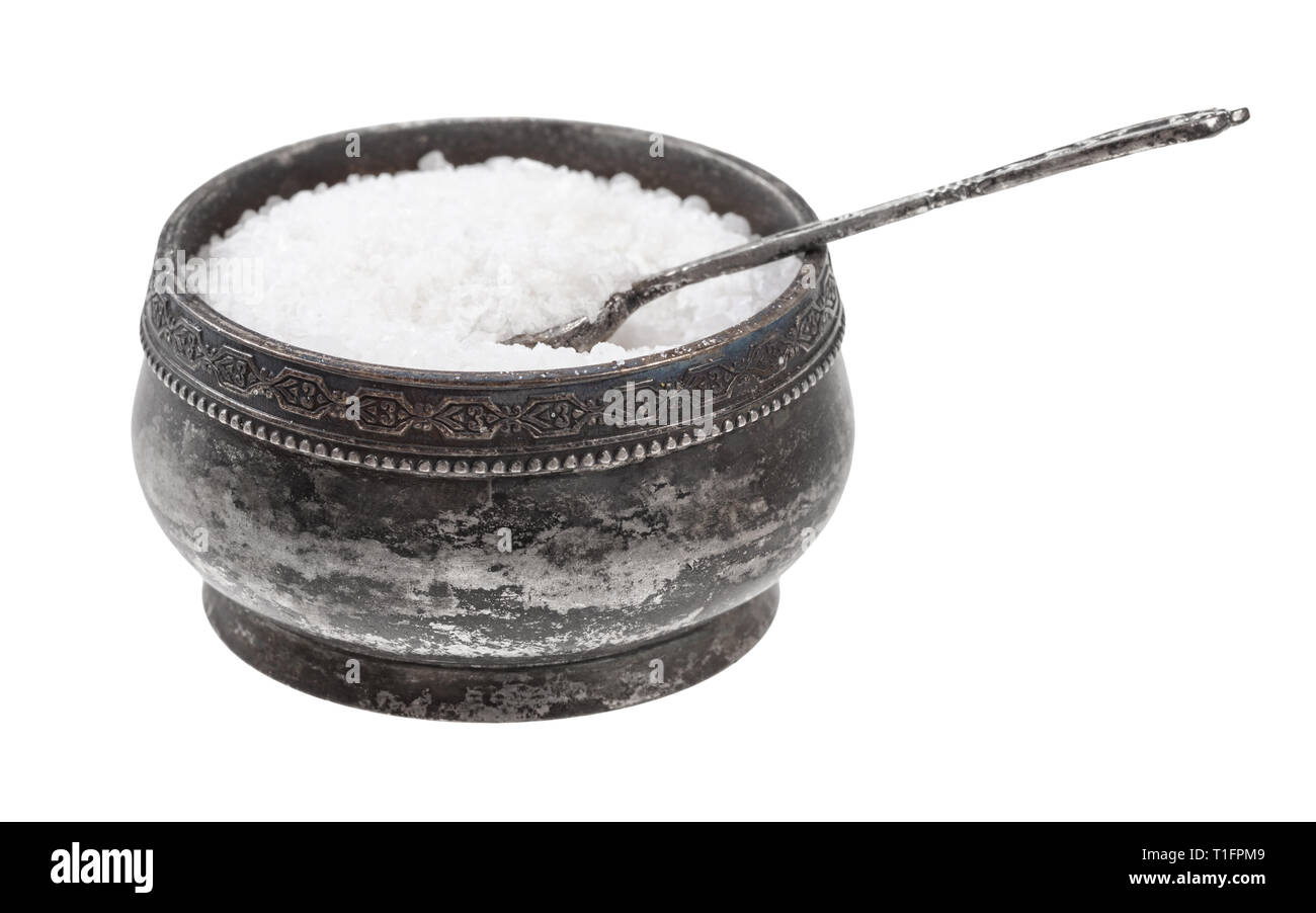 side view of old silver salt cellar with spoon with grained Rock Salt ...