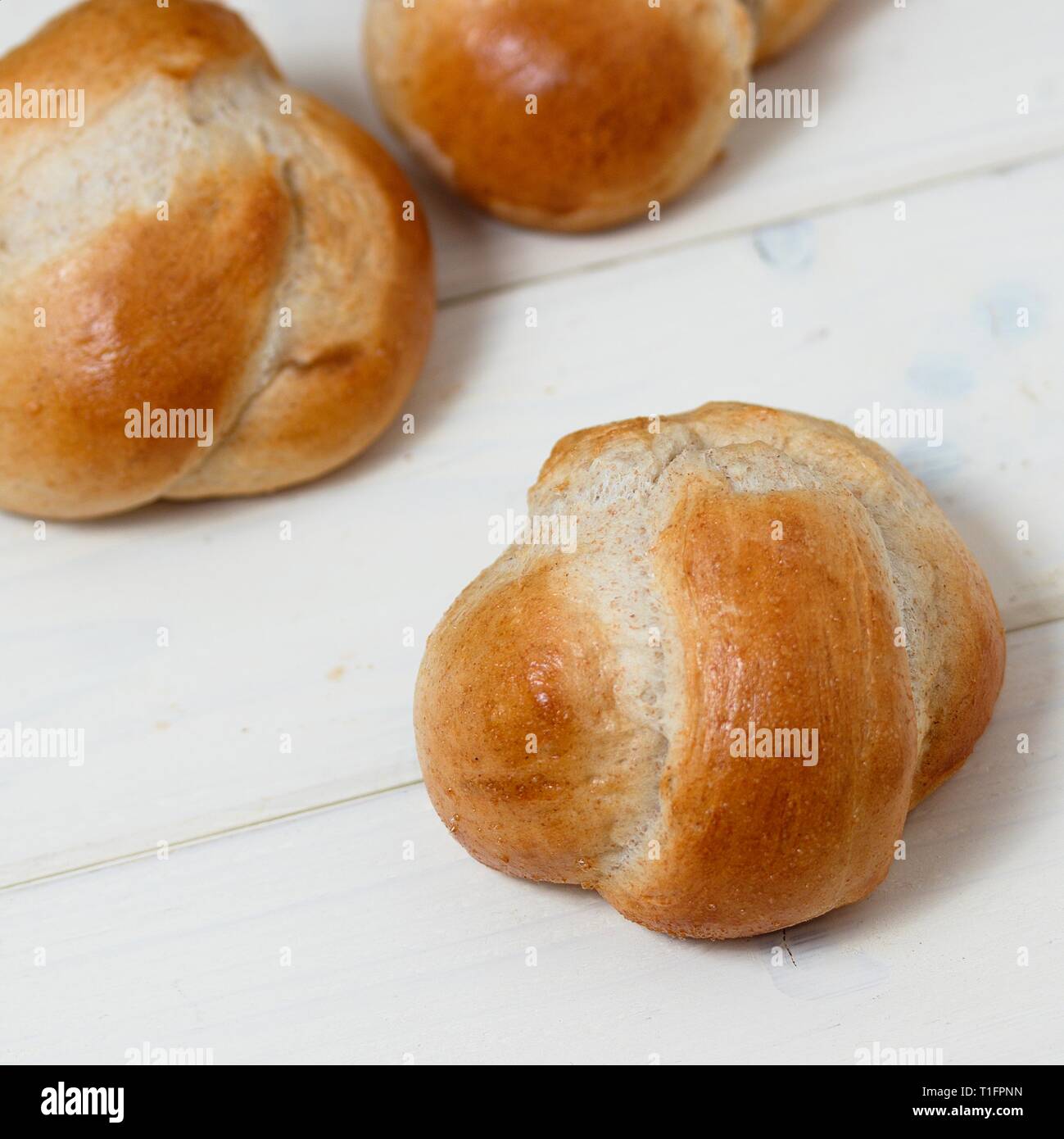 Three homemade breadrolls on white wooden surface. Fresh, hot,crispy ...
