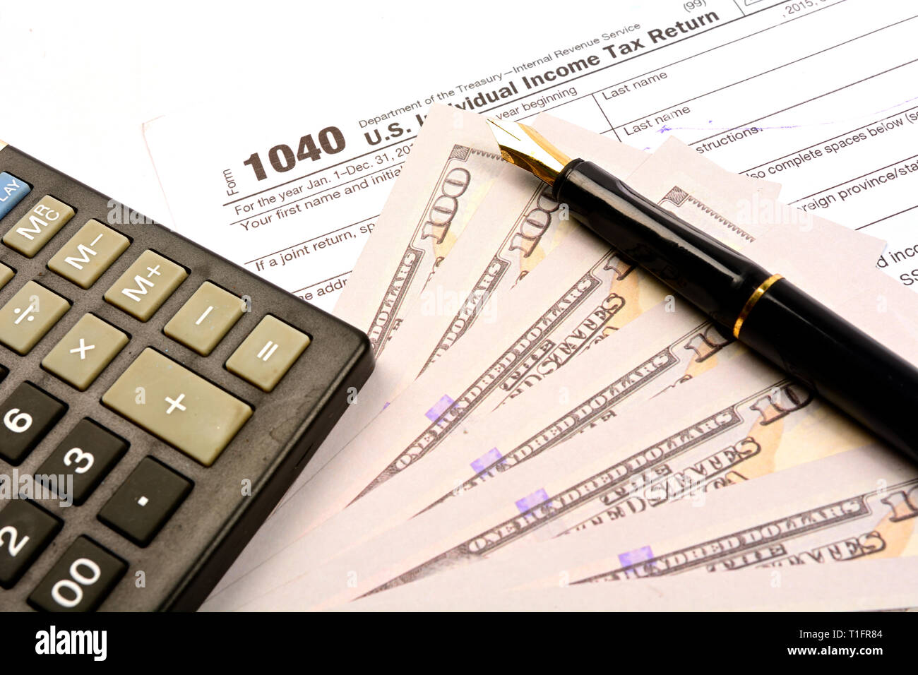 Completing US tax return form 1040 on white background Stock Photo - Alamy
