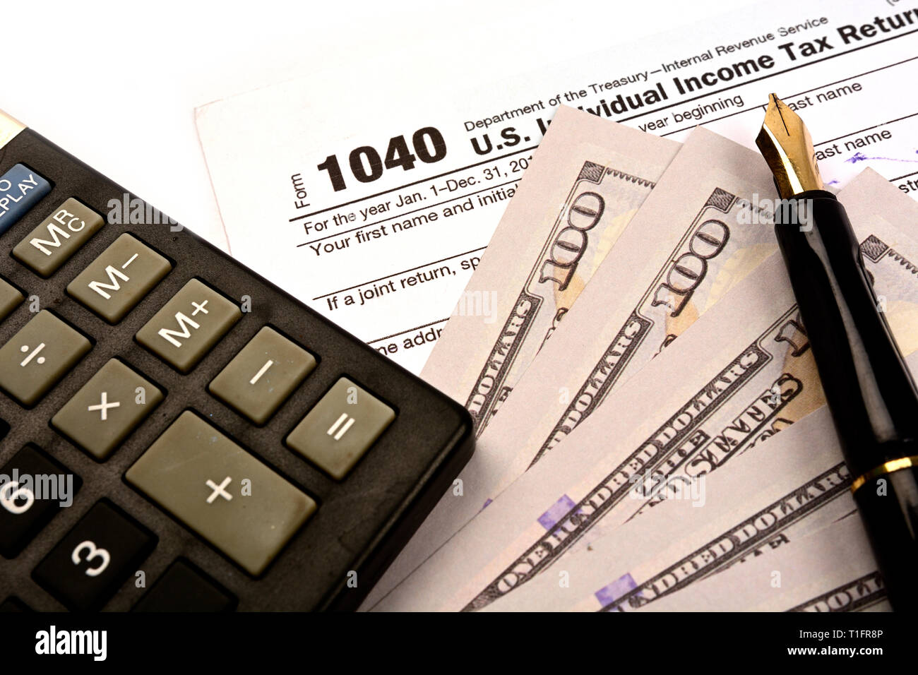 Completing US tax return form 1040 on white background Stock Photo - Alamy