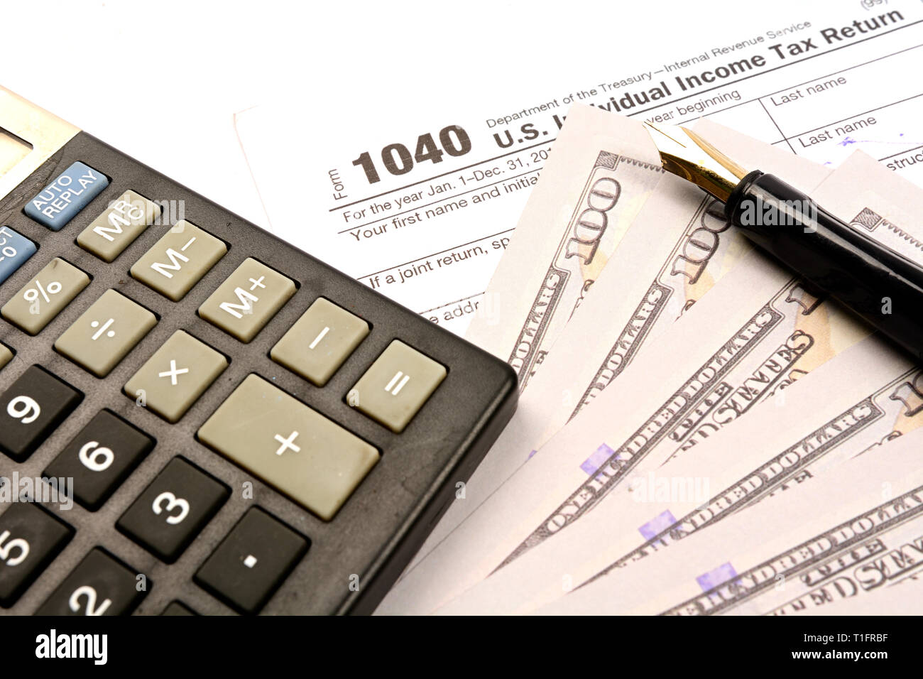 Completing US tax return form 1040 on white background Stock Photo - Alamy