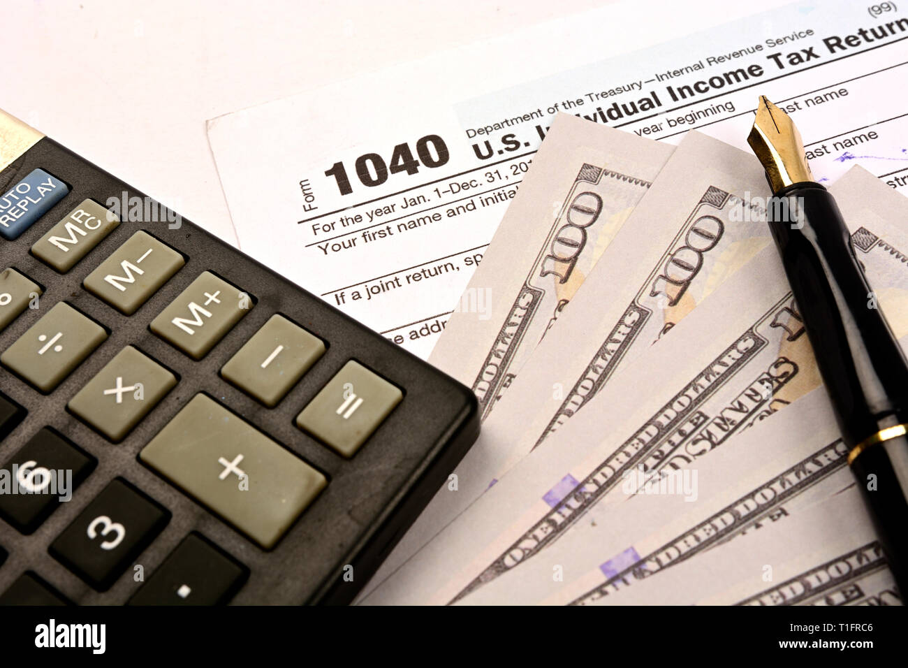 Completing US tax return form 1040 on white background Stock Photo - Alamy