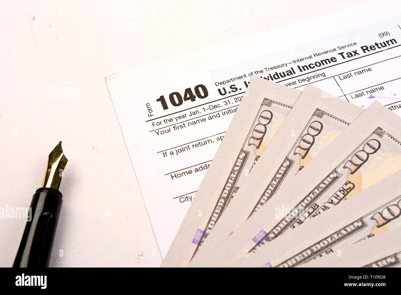 Completing US tax return form 1040 on white background Stock Photo - Alamy