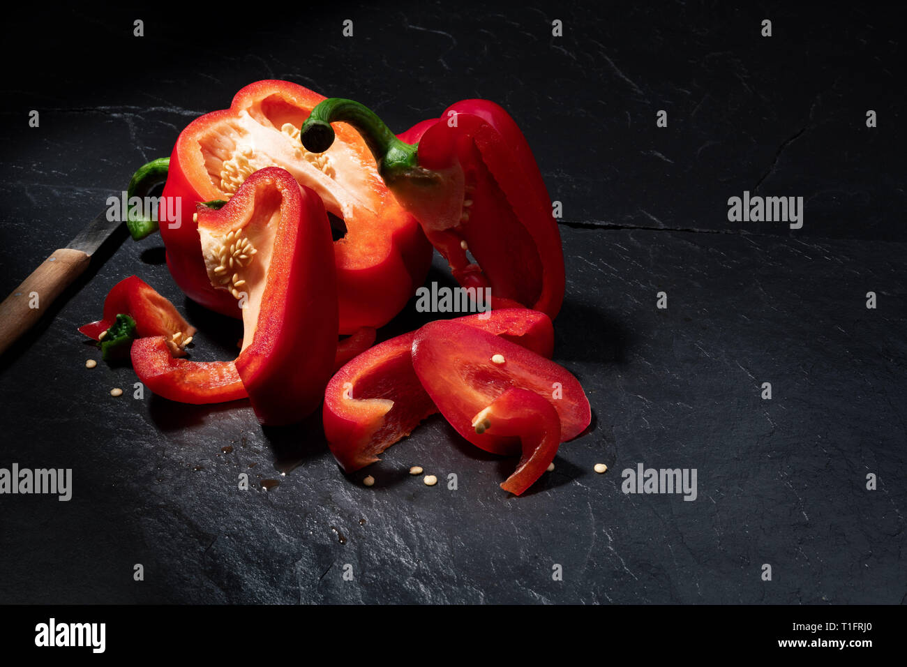 Beautiful pile of sliced red peppers on black slate plate Stock Photo ...