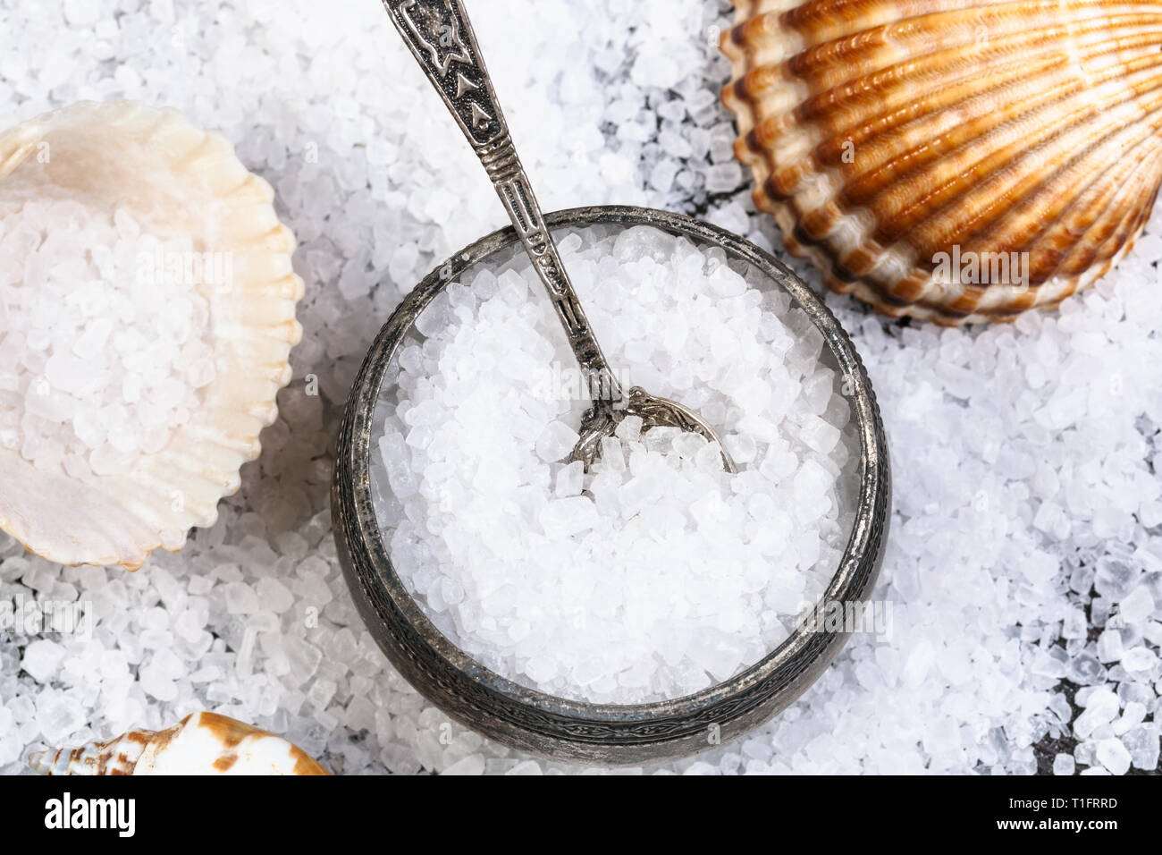 top view of salt cellar, shells and coarse grained Sea Salt close up ...