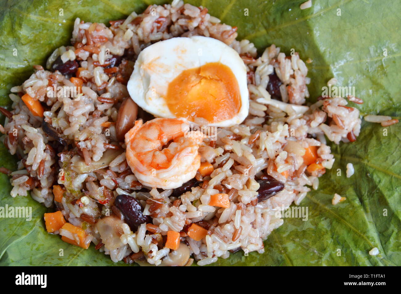 shrimp and salt egg topping on steamed rice wrapped in lotus leaf Stock ...