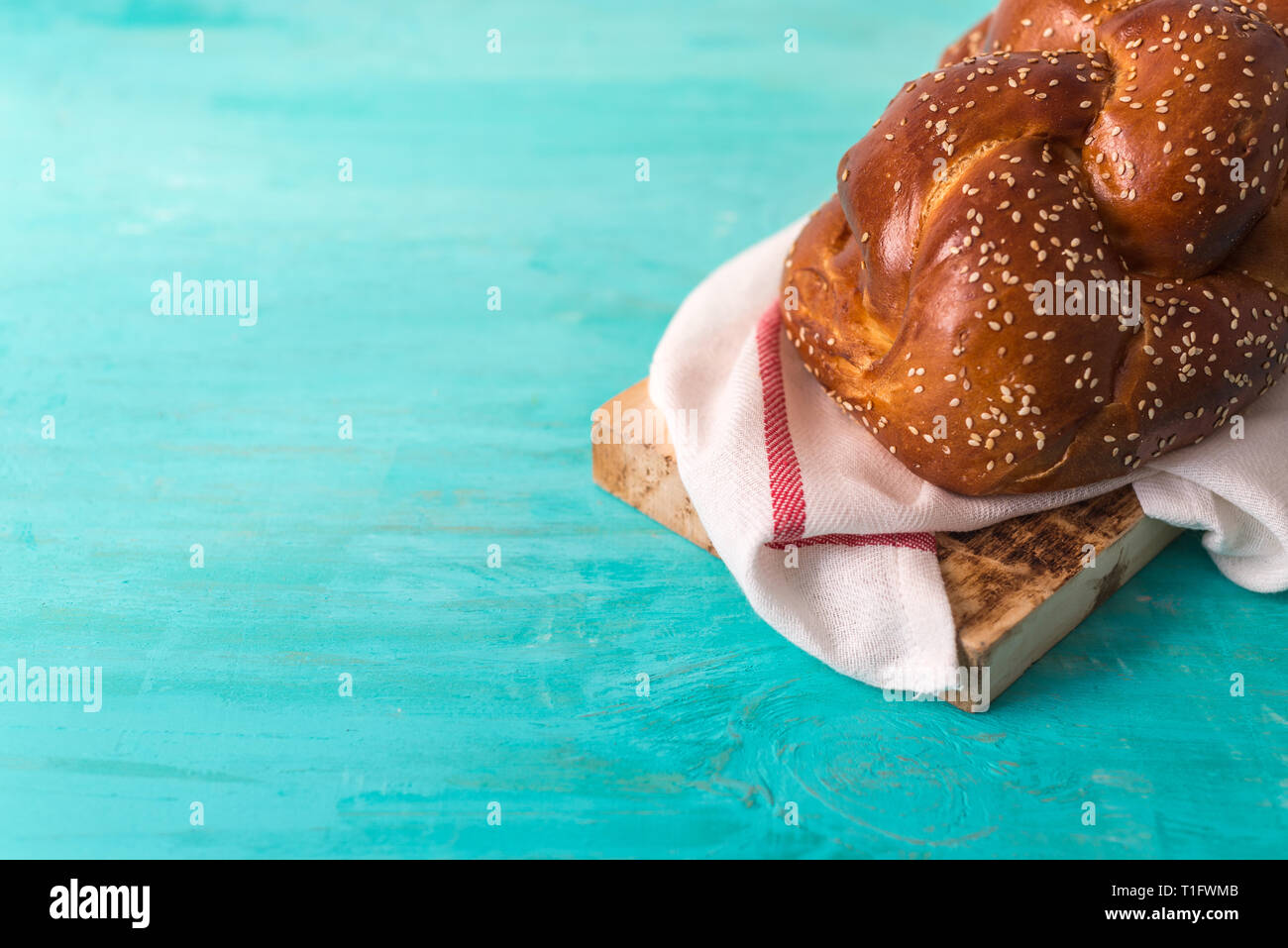 Challah bread on a wood plate on wooden table / white background with ...