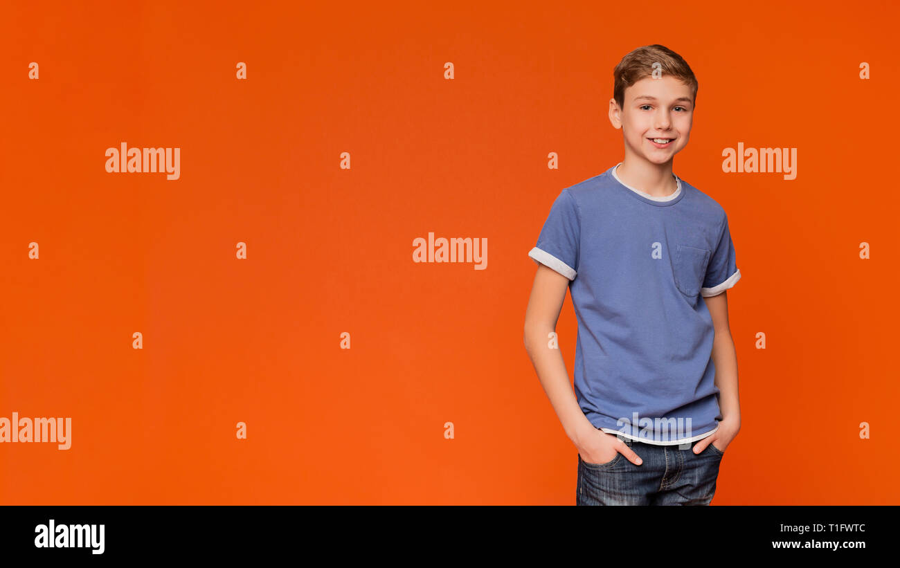Cute boy standing with hands in pockets Stock Photo - Alamy