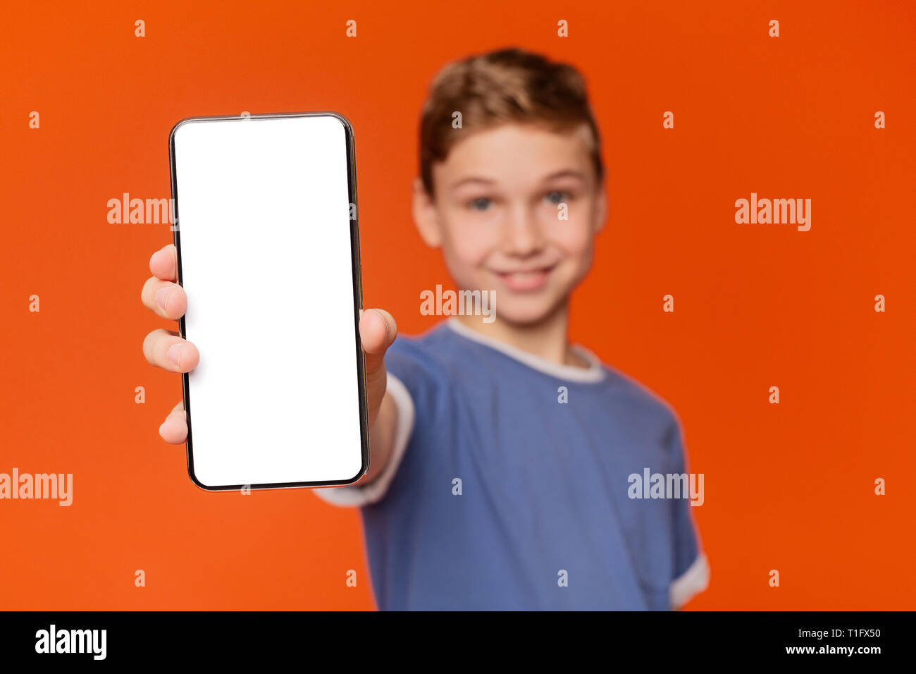 Cute boy man showing blank cellphone screen Stock Photo - Alamy