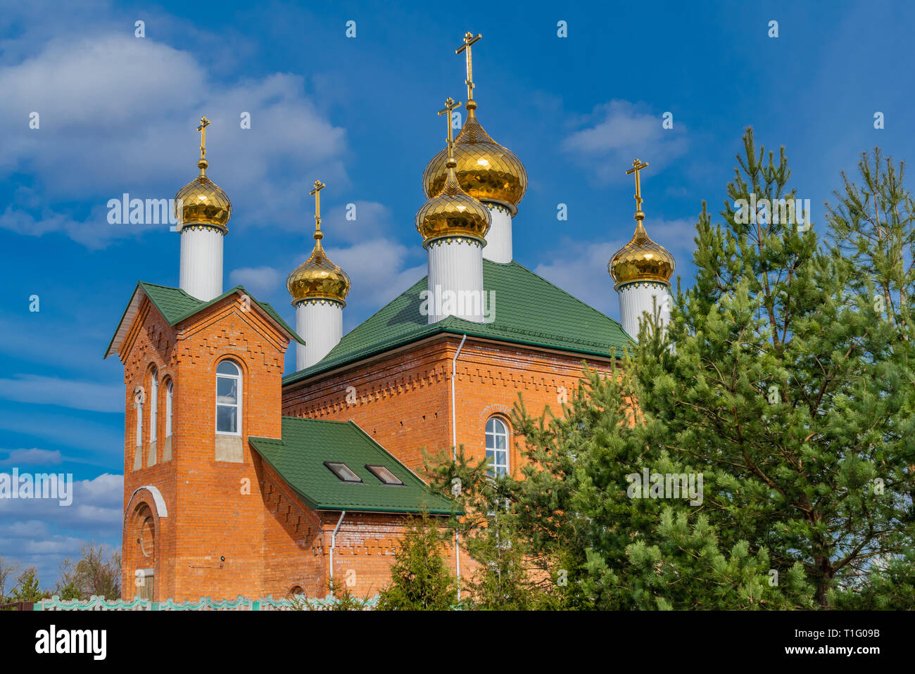 red brick christian church with golden domes against a blue sky Stock ...