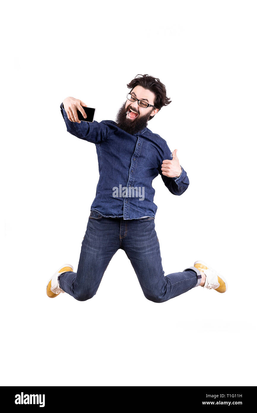 jumping positive man making selfie, isolated on white background Stock ...