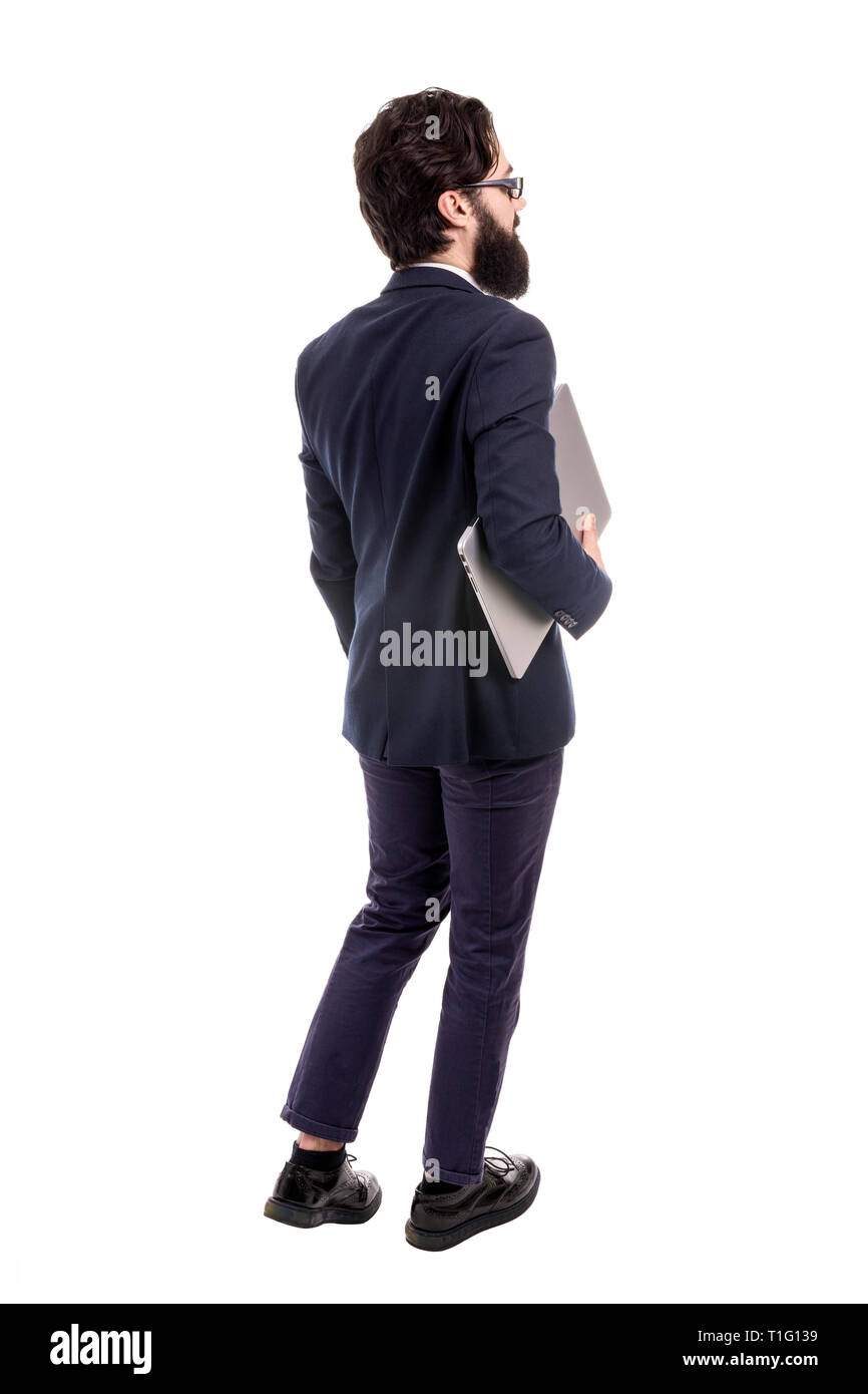from the back of a businessman holding laptop computer under his arm ...