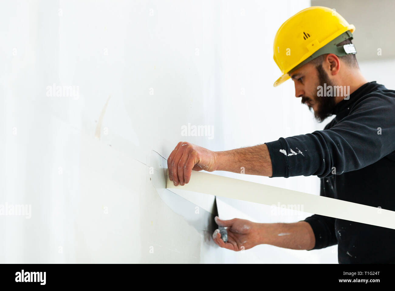 Interior construction, worker plastering gypsum board wall Stock Photo ...