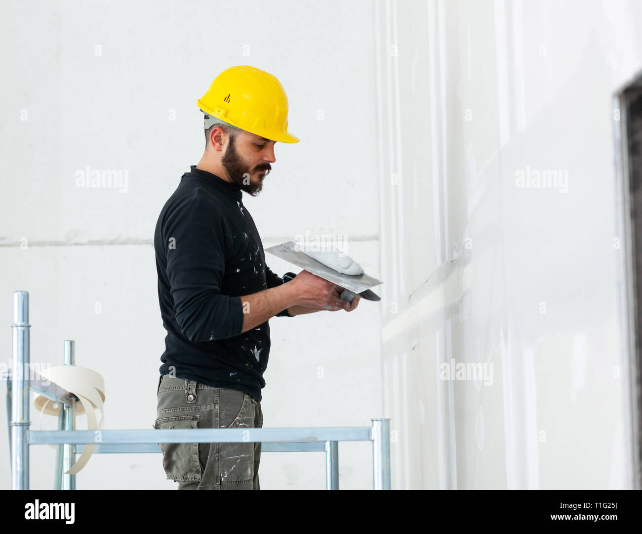 Interior construction, worker plastering gypsum board wall Stock Photo ...