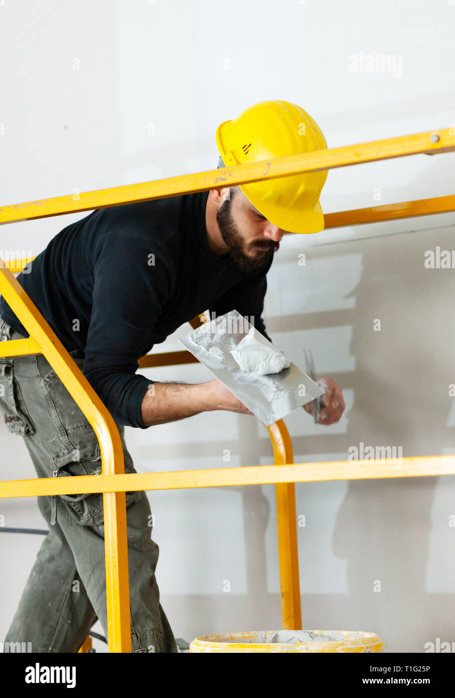 Interior construction, worker plastering gypsum board wall Stock Photo ...