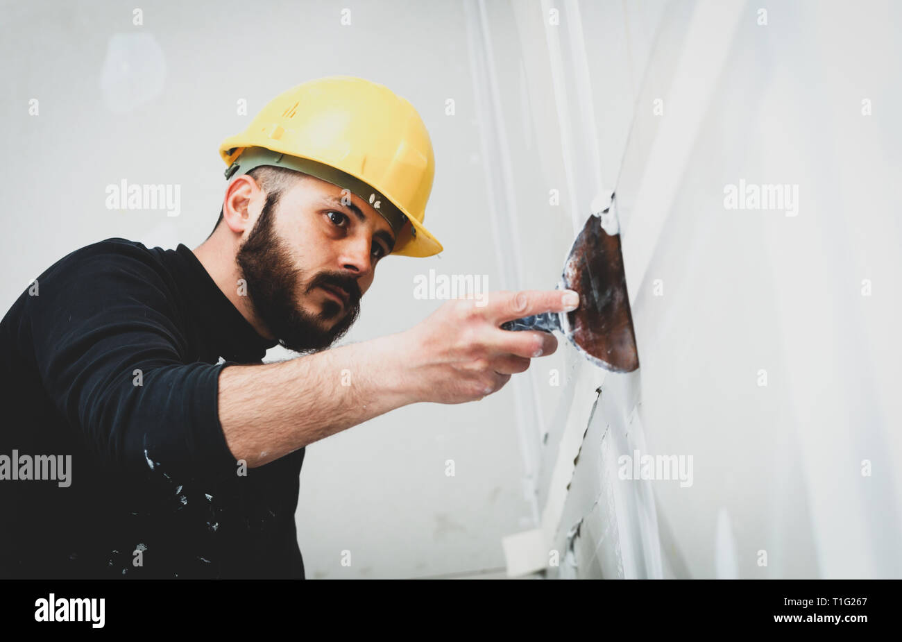 Interior construction, worker plastering gypsum board wall Stock Photo ...
