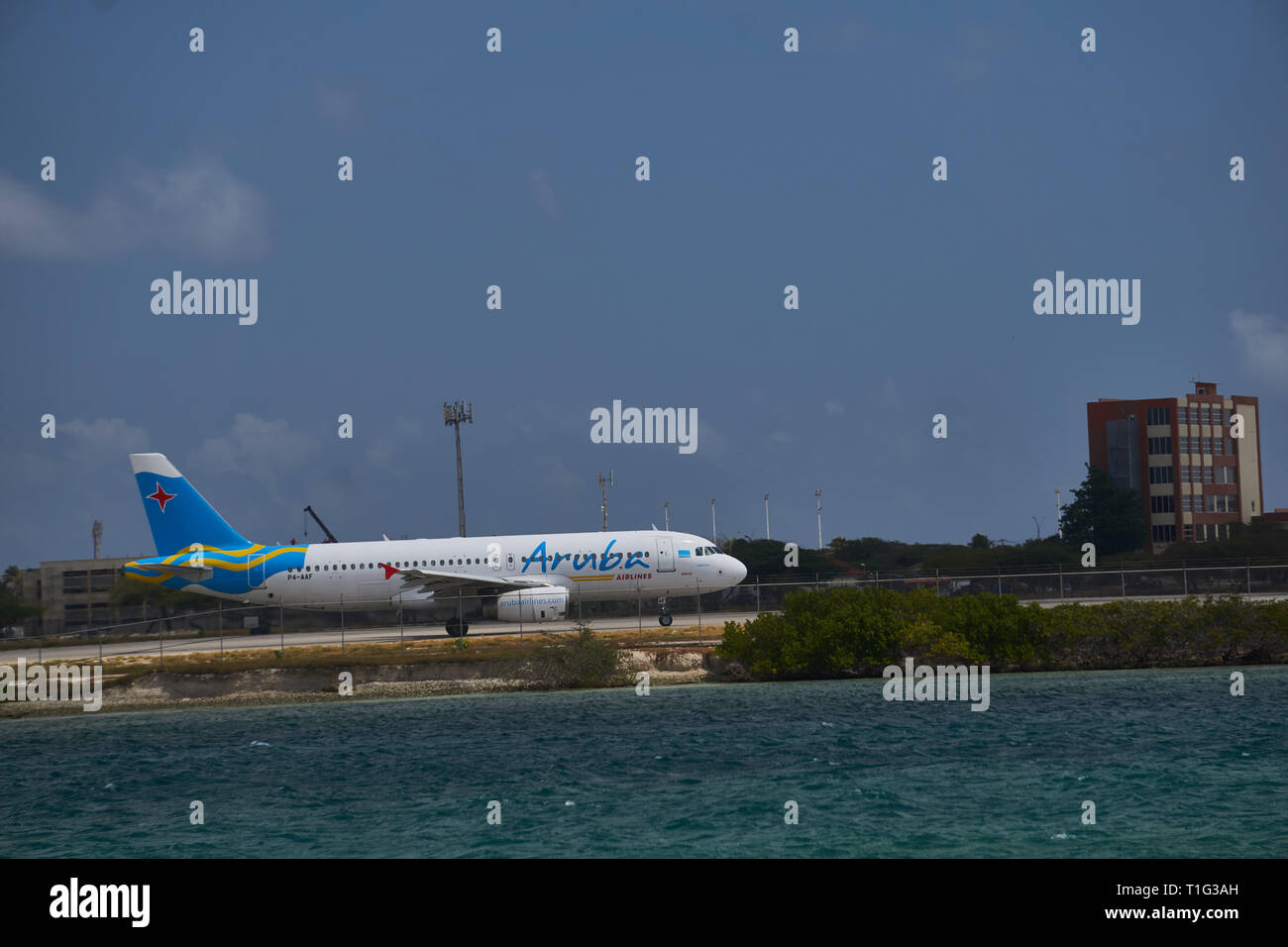 Plane landing in Aruba Airport Stock Photo - Alamy