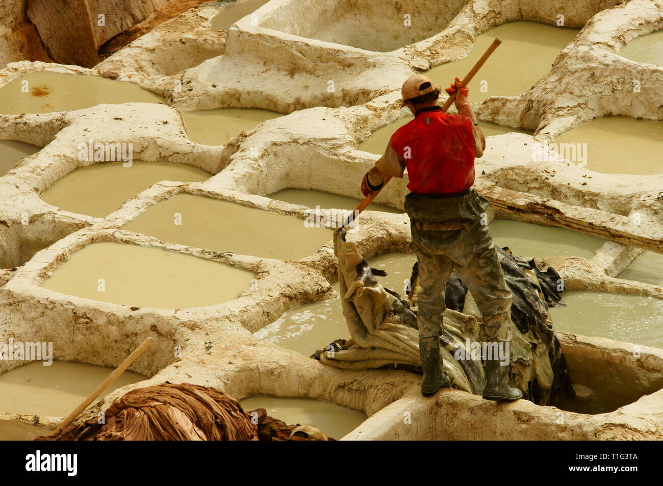 A Hard-working man. Old tanks with color paint for leather. Fes ...