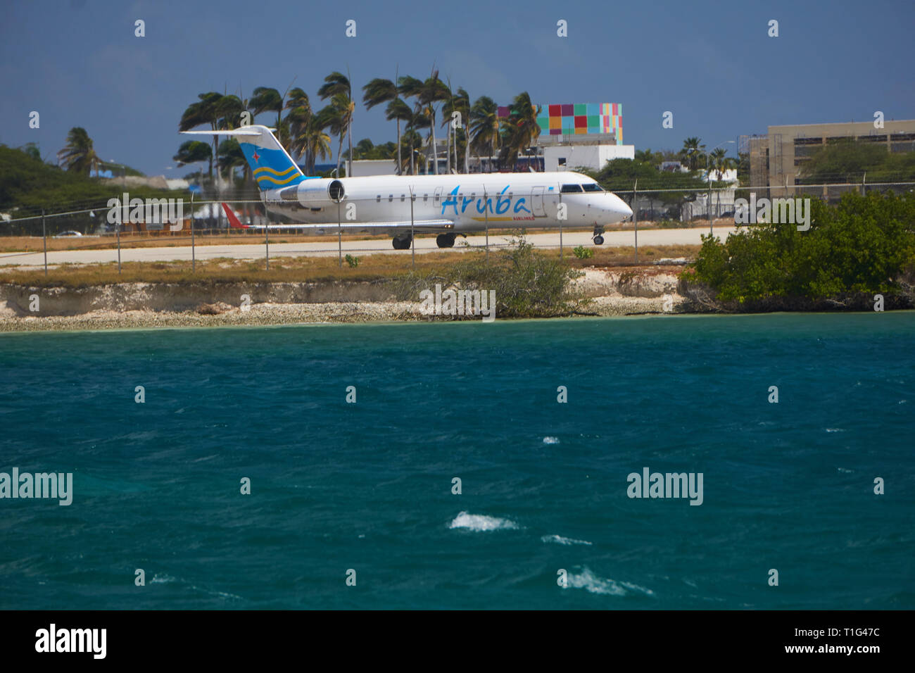 Plane landing in Aruba Airport Stock Photo - Alamy
