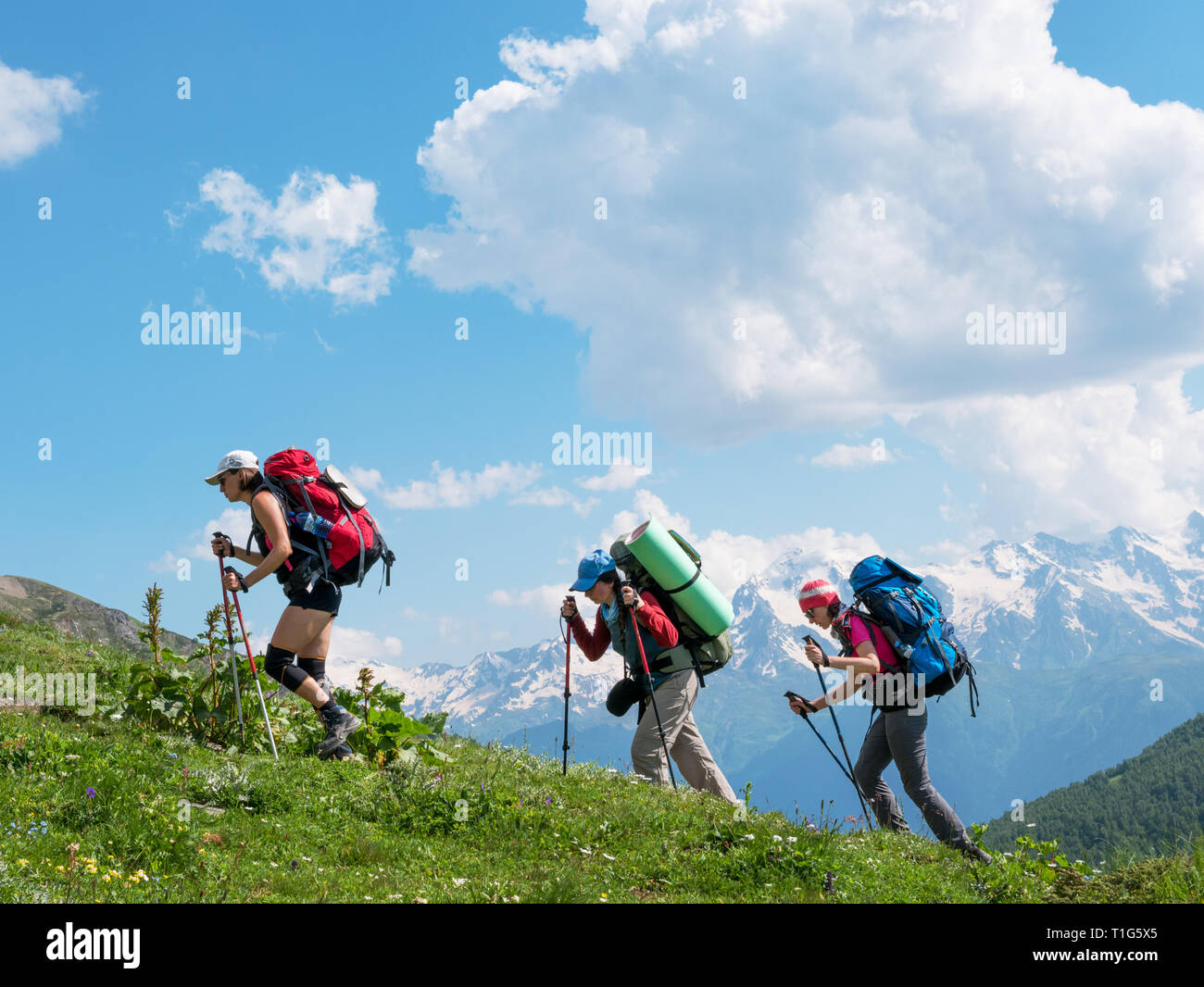 girls with heavy backpacks hiking in mountains Stock Photo - Alamy