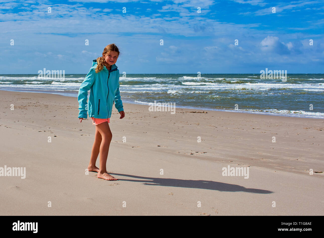 little girl is having fun at the beach in the late summer in Petten, North Netherlands Stock ...
