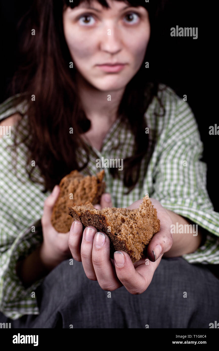 Beggar woman eating bread hi-res stock photography and images - Alamy