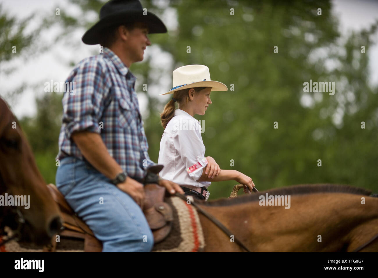 Father and daughter horseback riding Stock Photo - Alamy