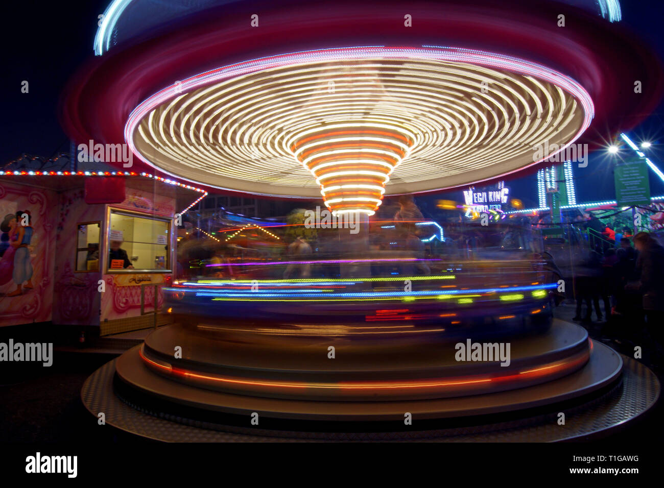 Carousel in neon light on a fairground in Karlsruhe at night Stock ...
