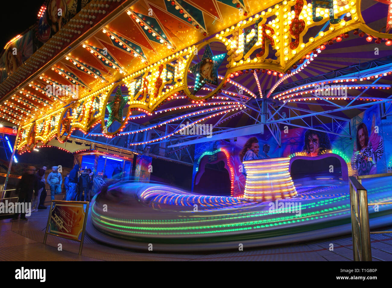 Carousel in neon light on a fairground in Karlsruhe at night Stock ...