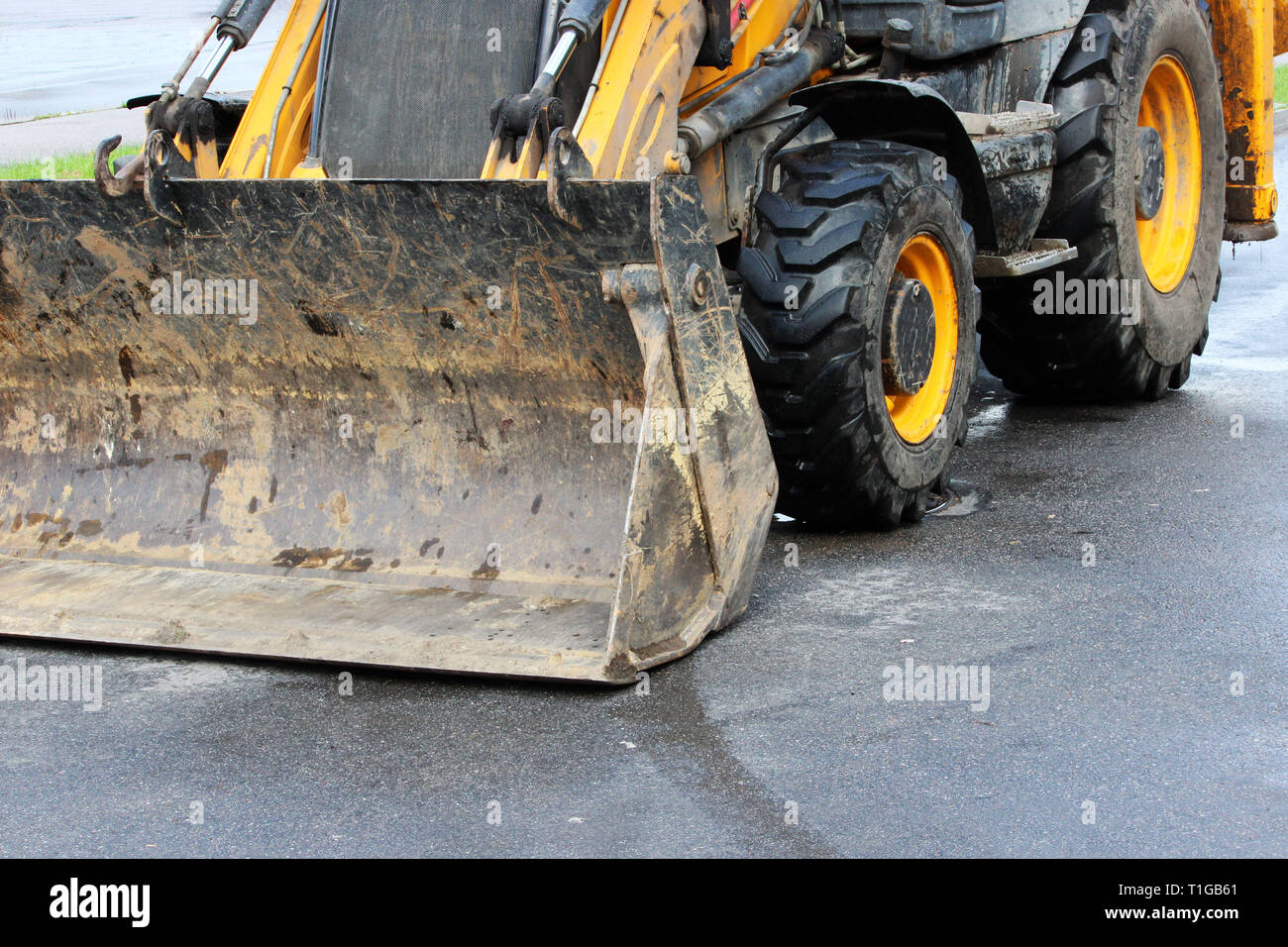 dozer blade of the tractor. Road repair extension in Gatchina, Russia ...