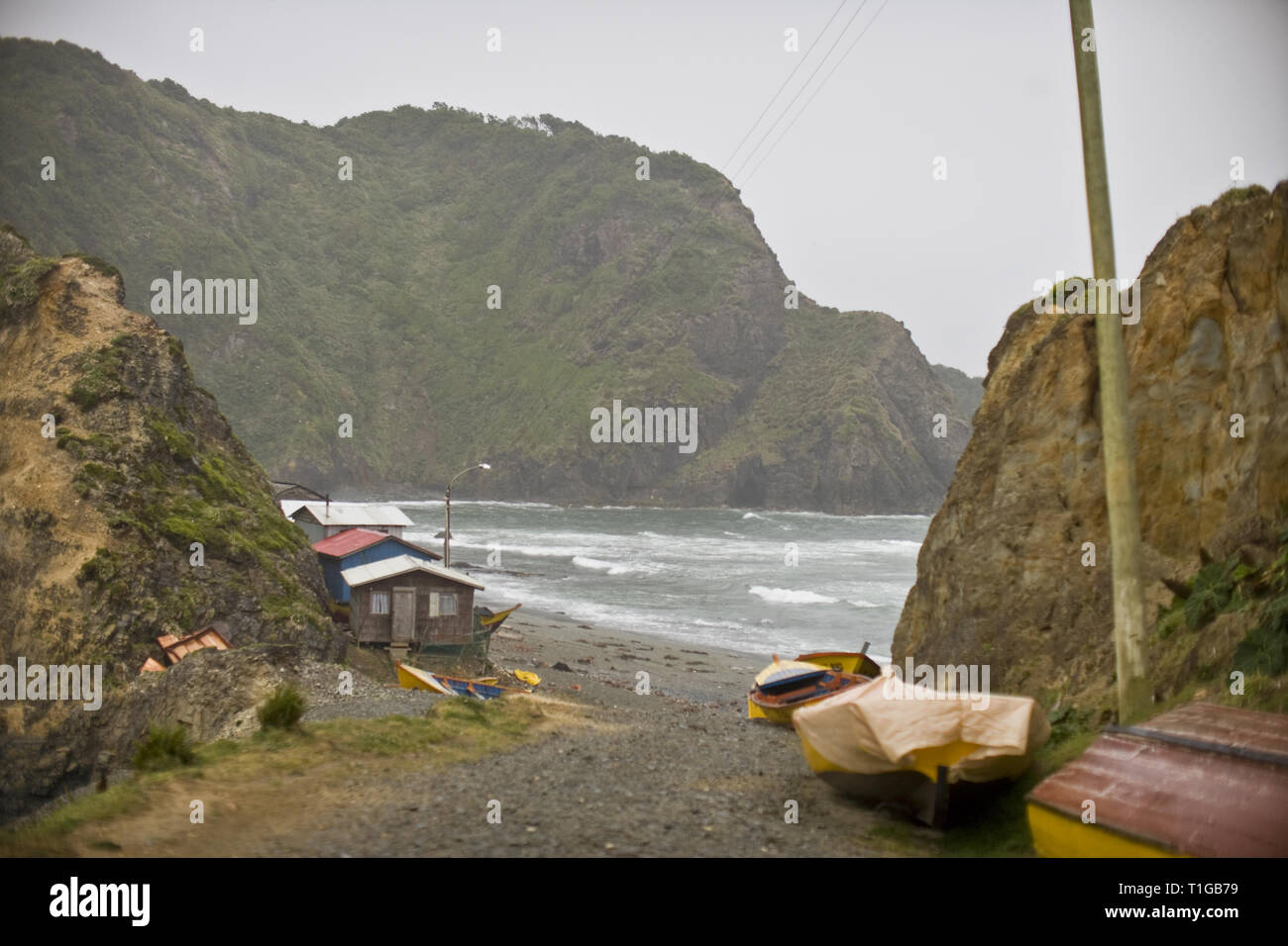 Old boats and a hut on a remote beach Stock Photo - Alamy