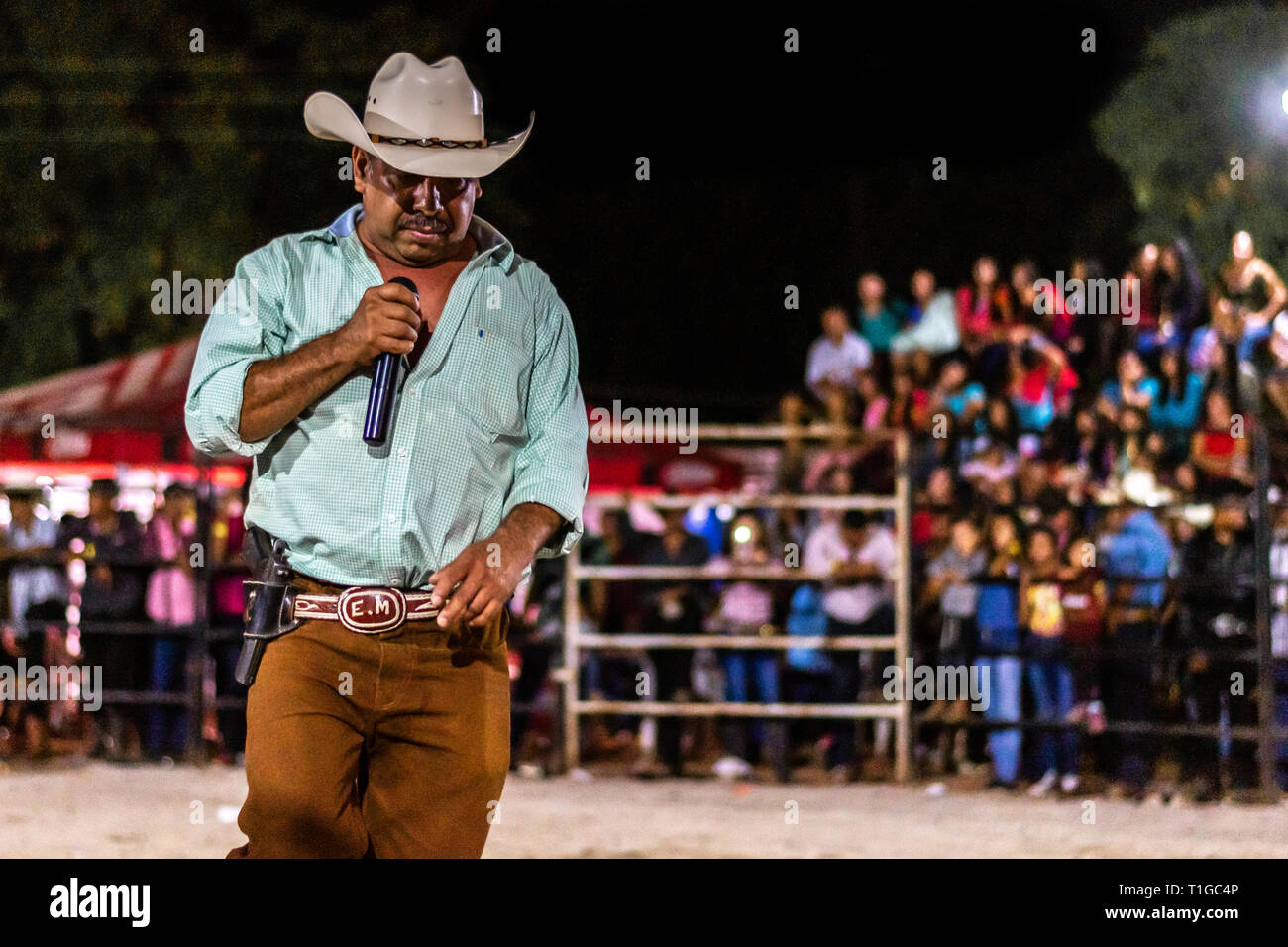 latin man with gun singing in Guatemalan rodeo Stock Photo - Alamy