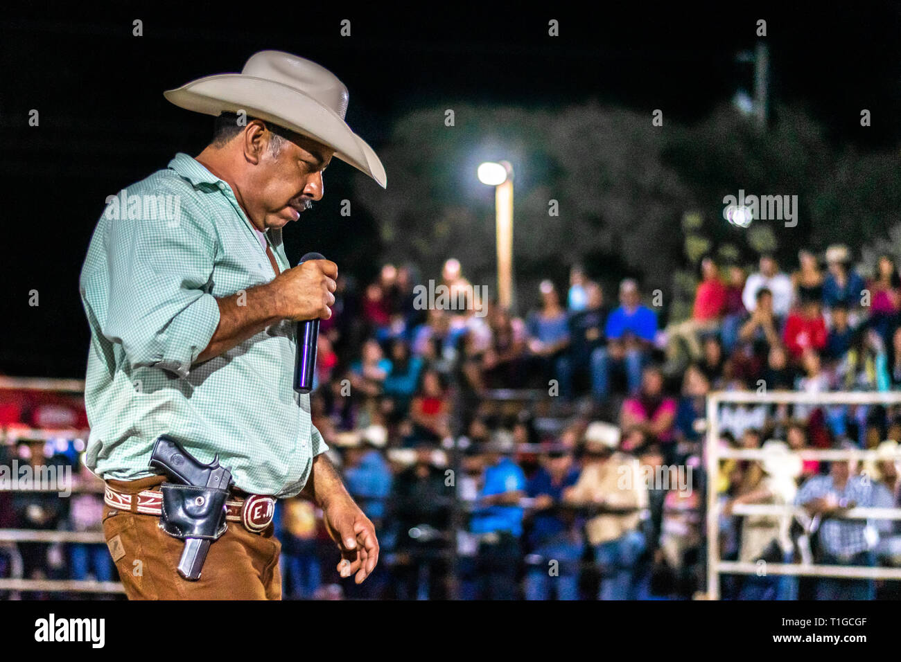 latin man with gun singing in Guatemalan rodeo Stock Photo - Alamy