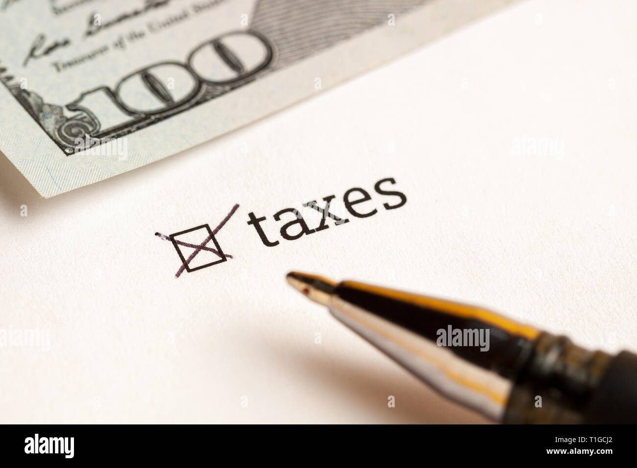 Checked checkbox with word taxes and dollars at background ...