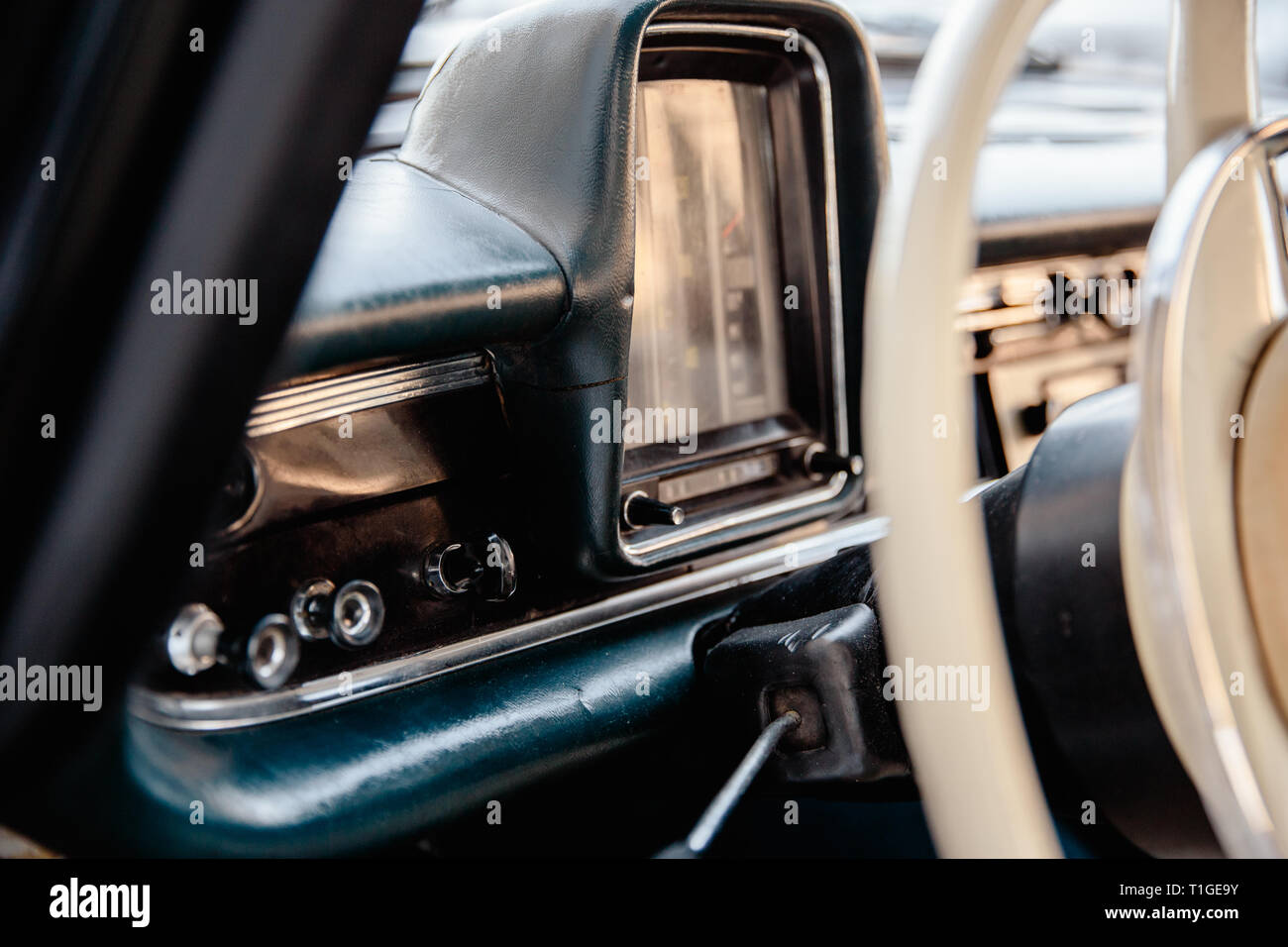 Retro styled image of an old car radio and dashboard inside a classic ...