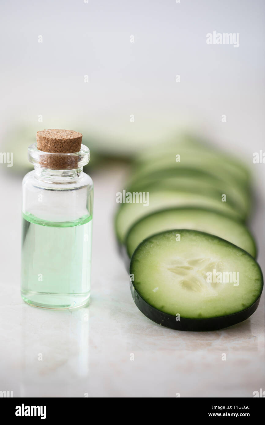 Cucumber slices and small bottle of cucumber extract Stock Photo - Alamy