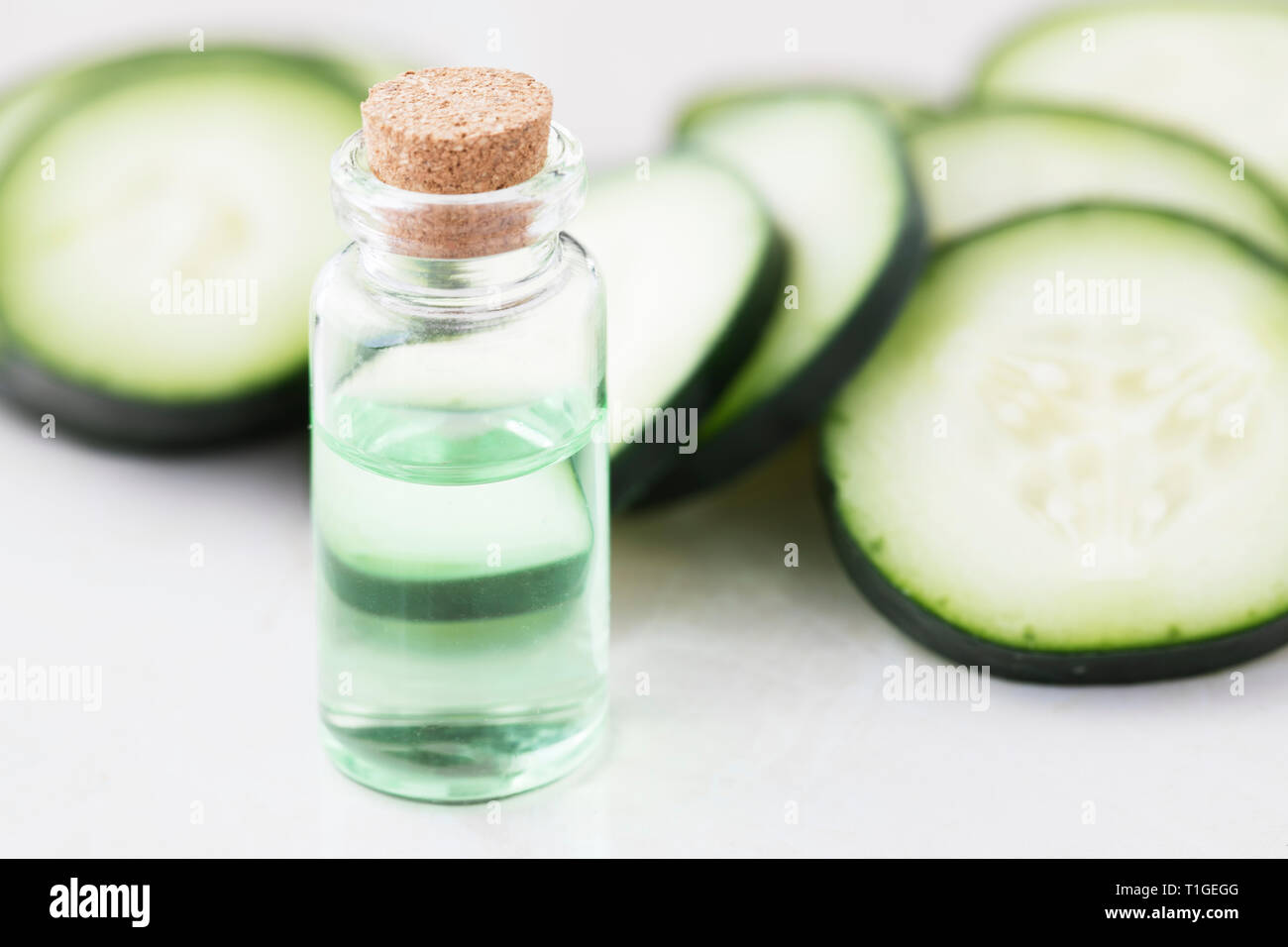 Cucumber slices and small bottle of cucumber extract Stock Photo - Alamy