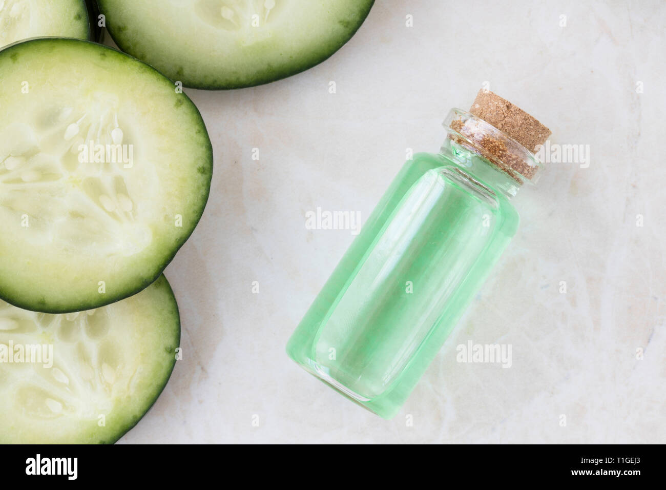 Cucumber slices and small bottle of cucumber extract flat lay Stock ...