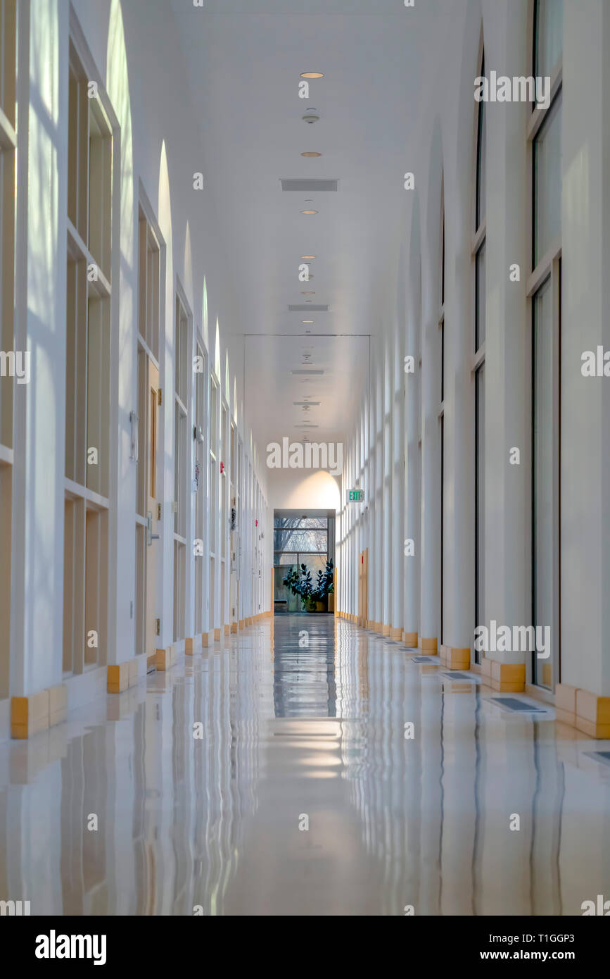 Interior hallway of a building with sunlit walls. Interior hallway of a ...