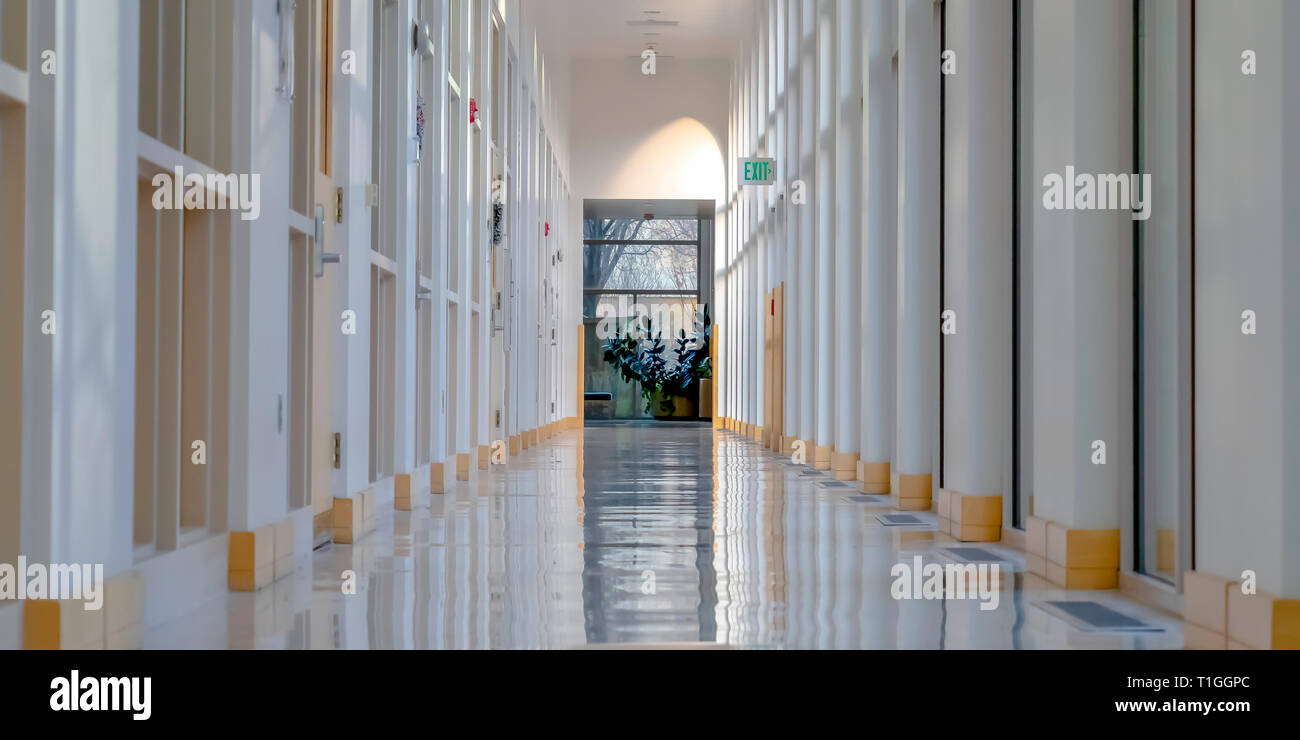 Interior hallway with shiny floor and sunlit walls. Interior hallway ...