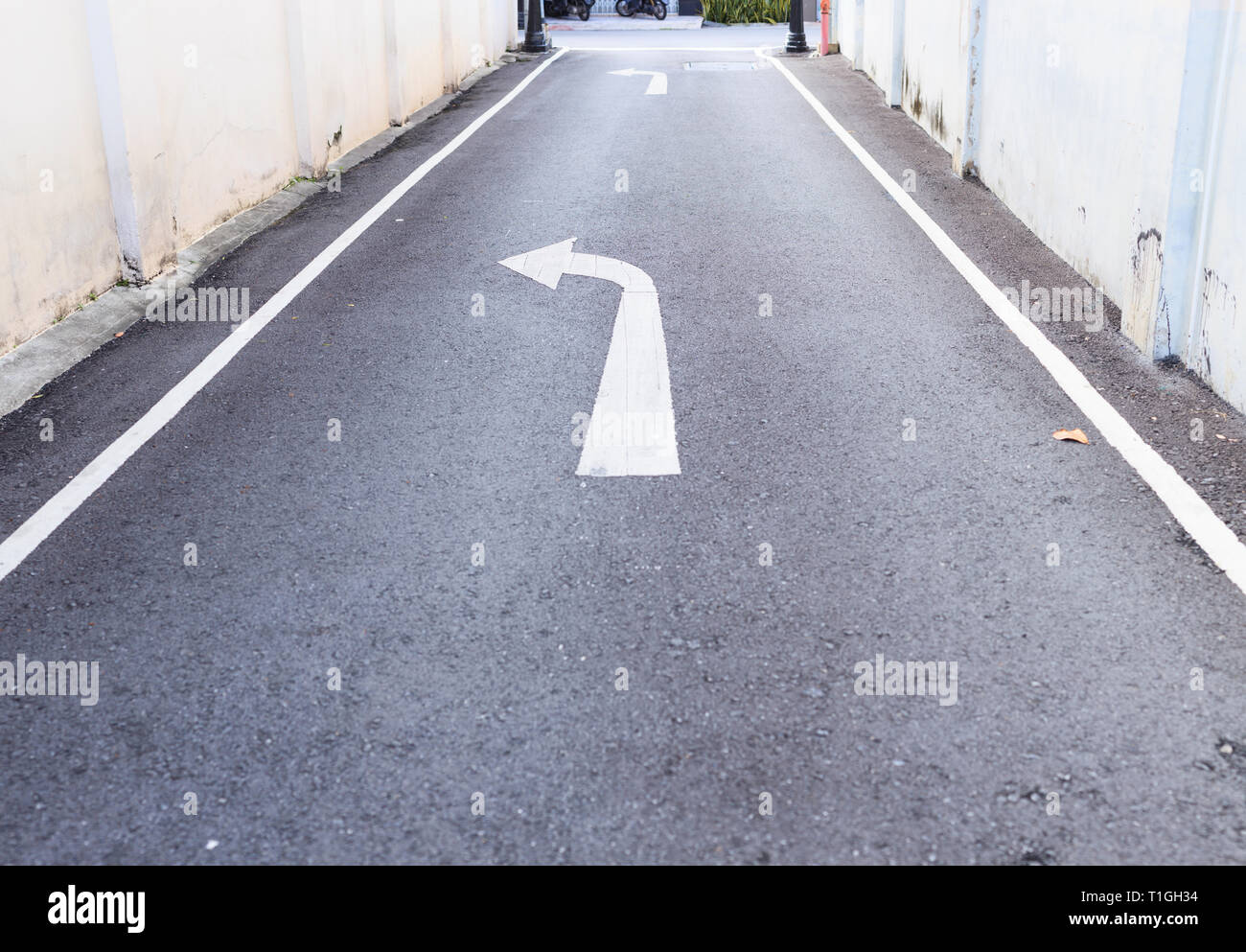 white arrow traffic sign indicates minor road to turn left to major ...