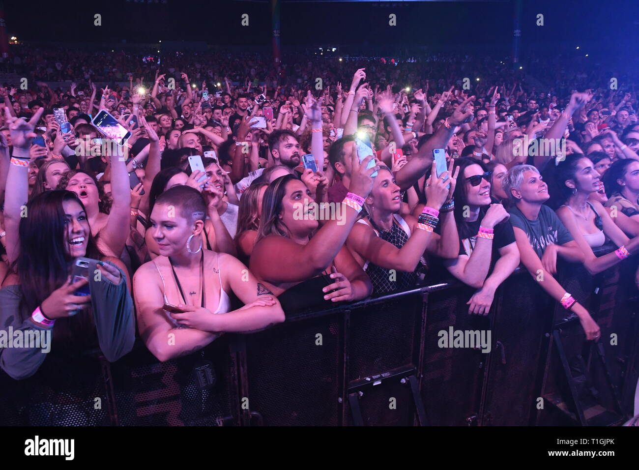 A packed crowd of over 10,000 fans are shown in an amphitheater during ...