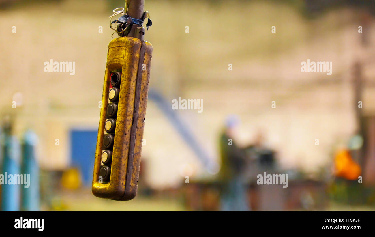 A lifting machine on the plant. A control panel hanging in the air ...