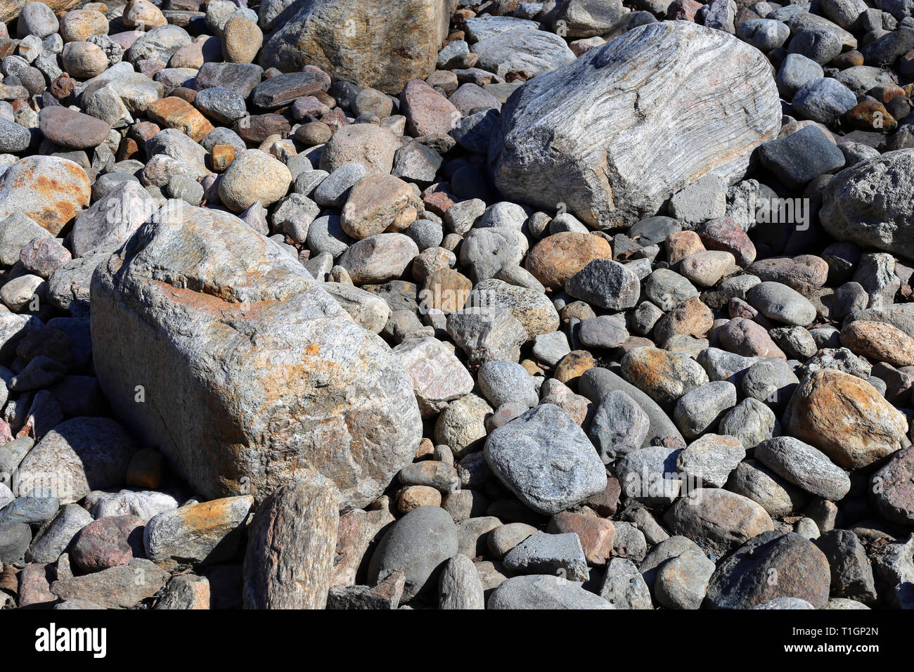 Plenty of colorful small, medium sized and big rocks in all different ...